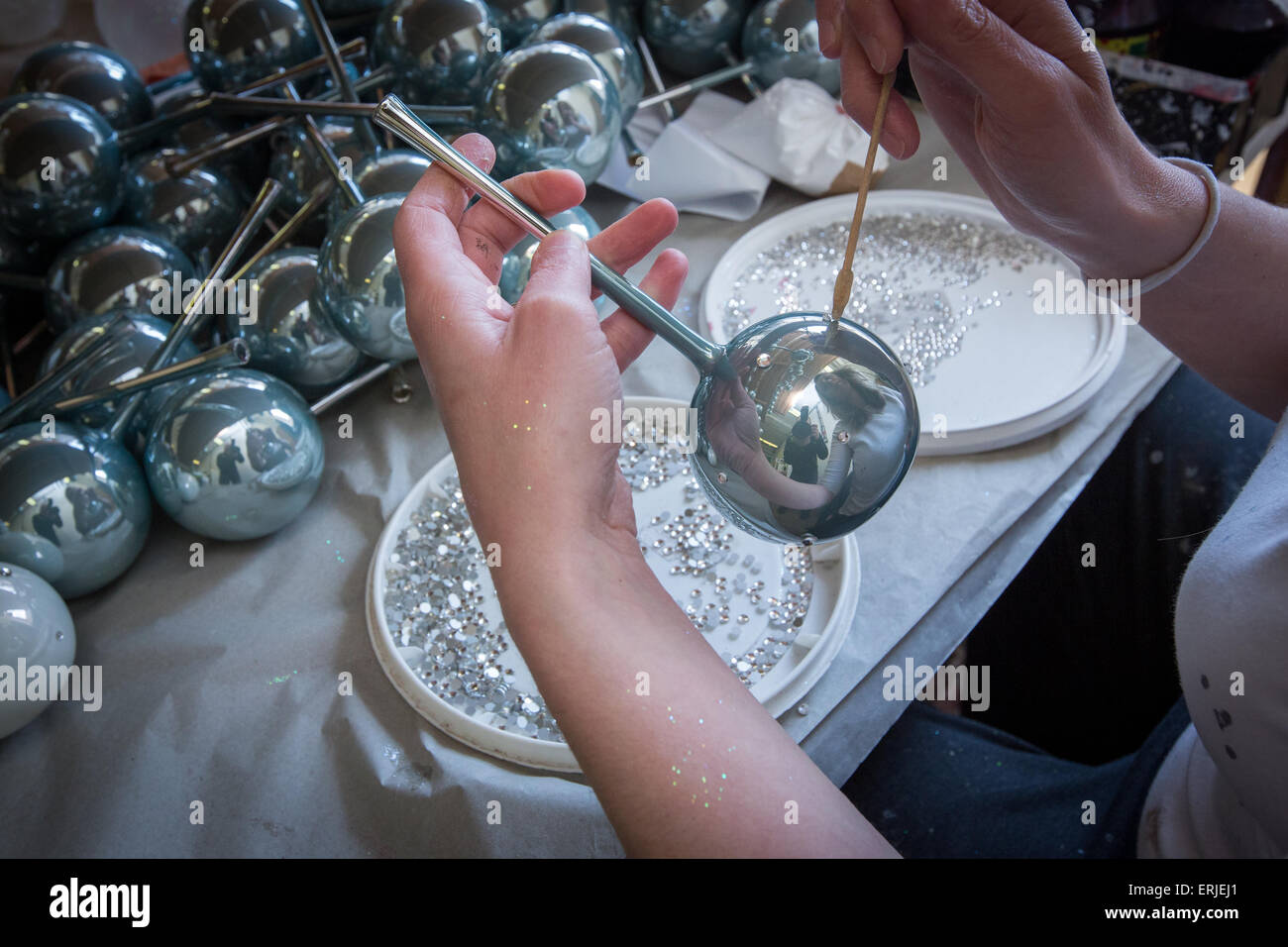 Worker completes glass ornaments in Slezska Tvorba factory in Opava ...