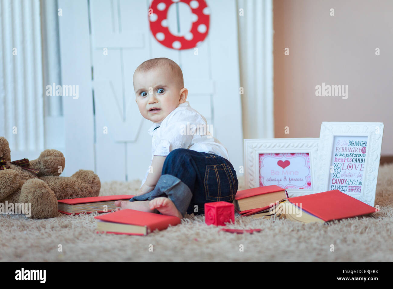 Funny baby with books Stock Photo - Alamy