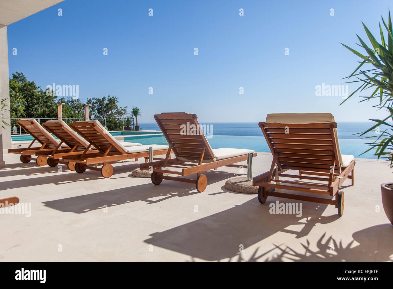 Luxury swimming pool and deck chair Stock Photo - Alamy
