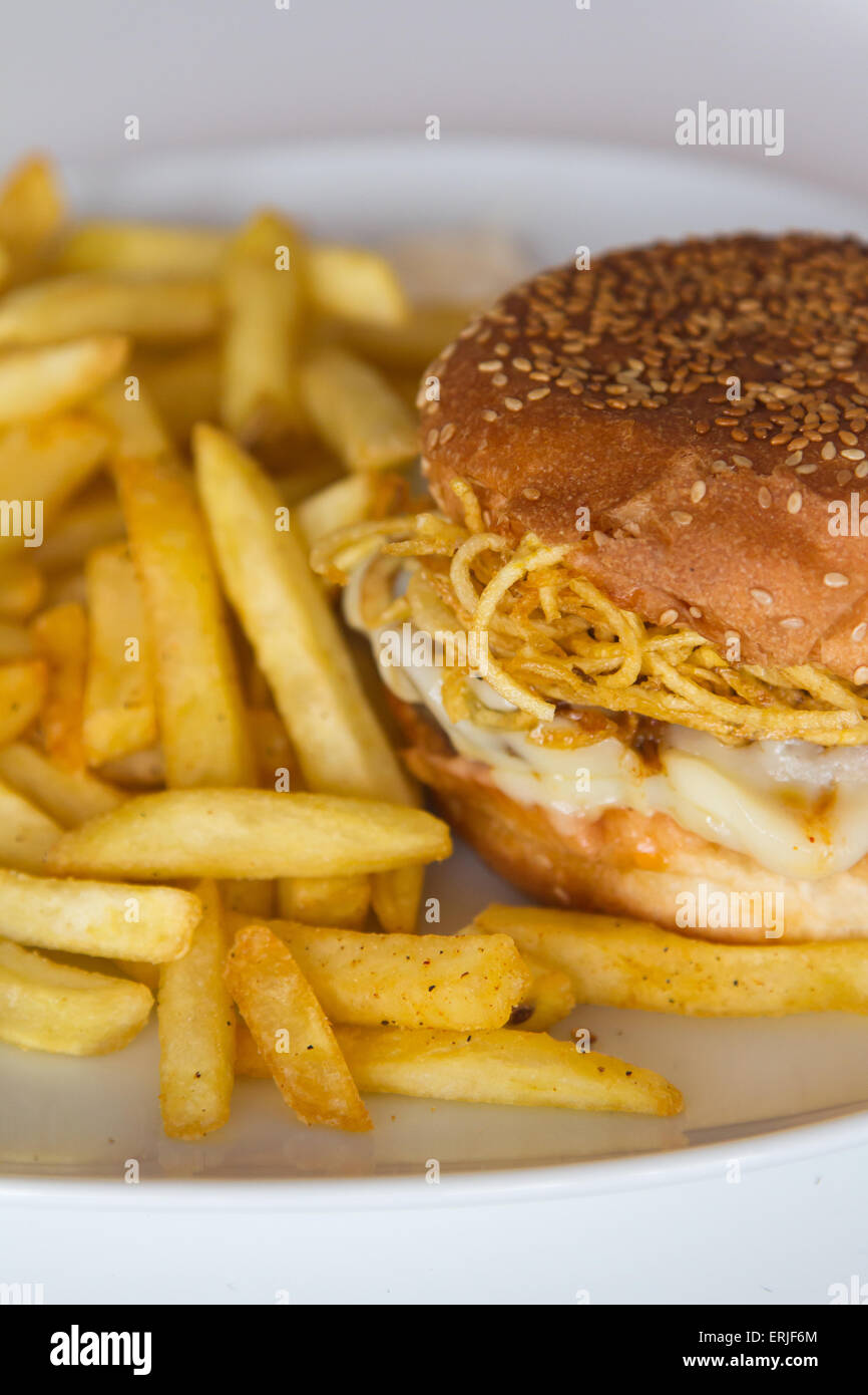 Close up view of hamburger with sliced potatoes Stock Photo - Alamy