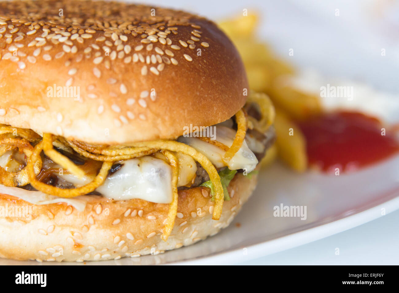 Close up view of hamburger with sliced potatoes Stock Photo - Alamy