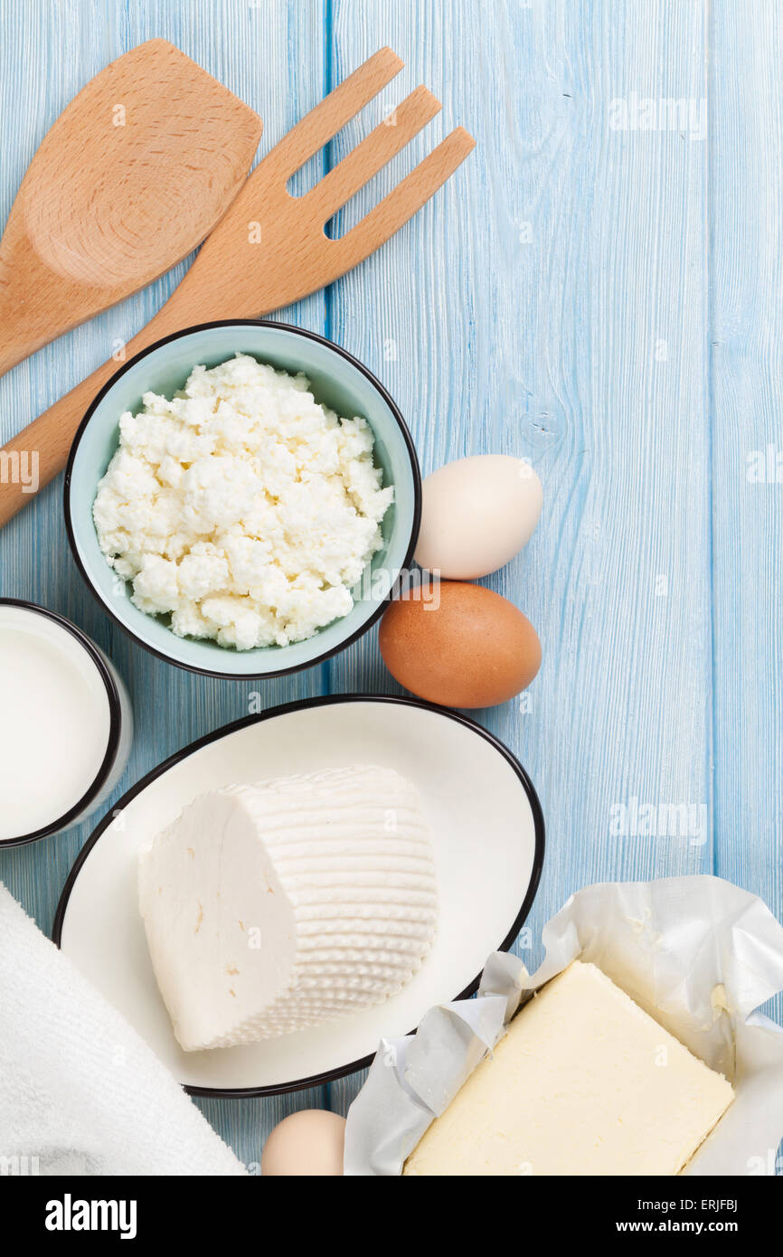 Dairy products on wooden table. Milk, cheese, egg, curd cheese and ...