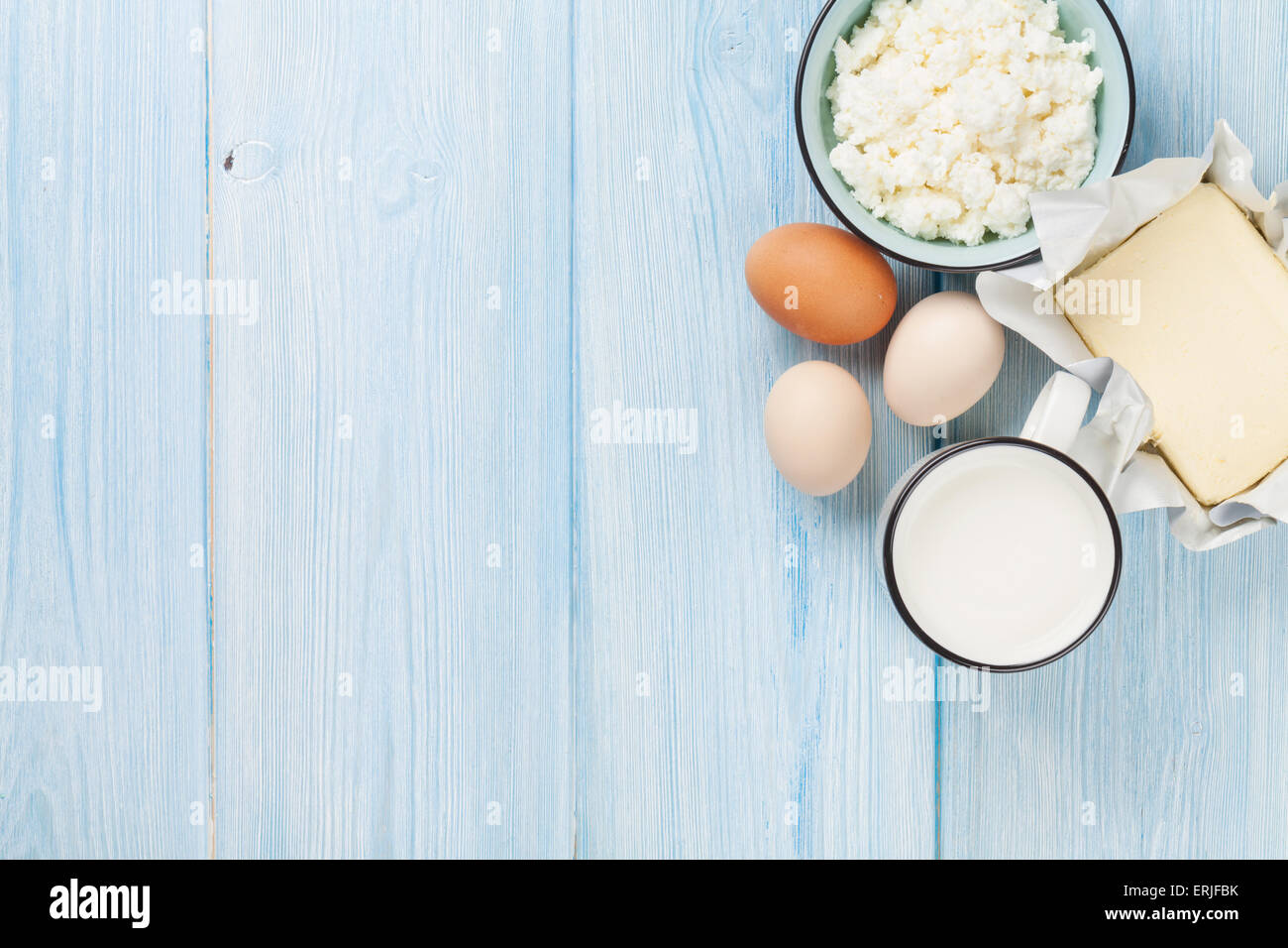Dairy products on wooden table. Milk, cheese, egg, curd cheese and ...