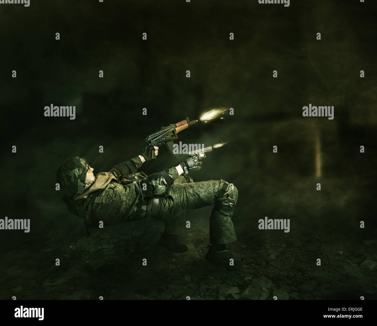 Military man warrior evades from a shot and shoots from two hands from ...