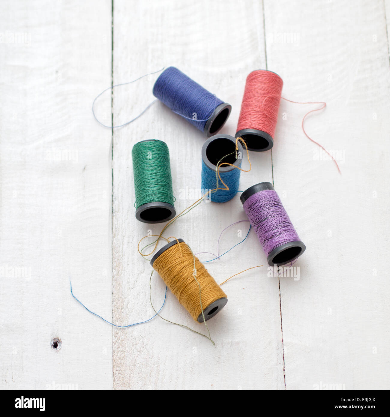 bobbins with thread on the table, from above Stock Photo - Alamy