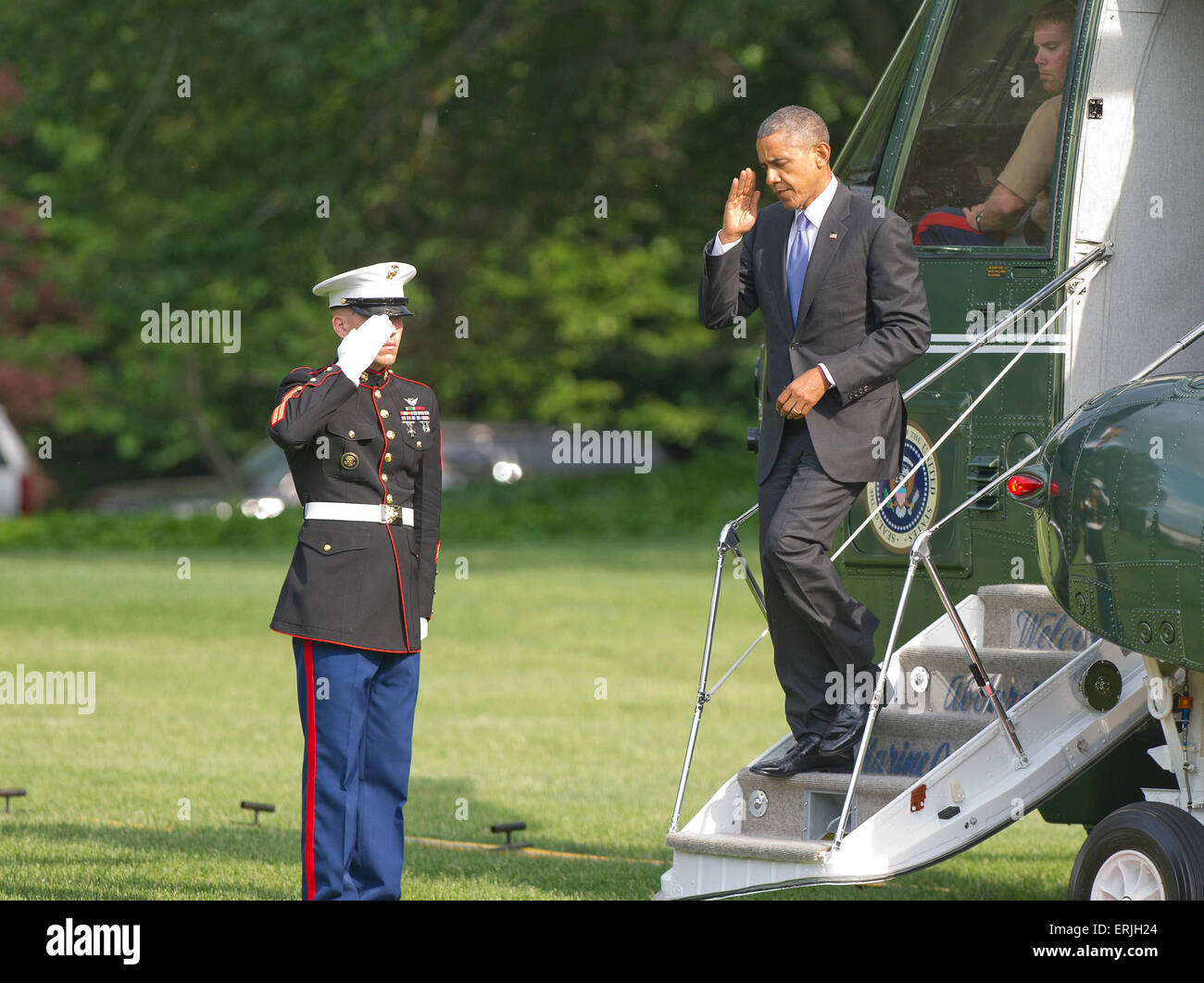 United States President Barack Obama salutes the Marine Guard as he ...