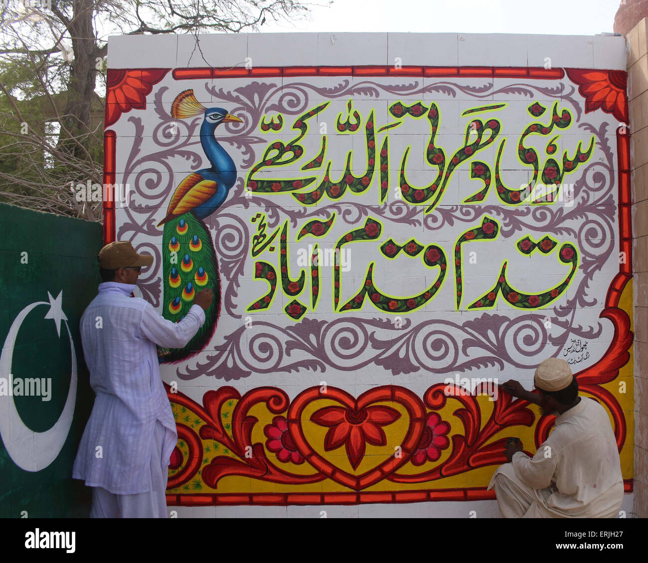 Artists busy in painting on wall of Sindh Assembly Building in Karachi ...