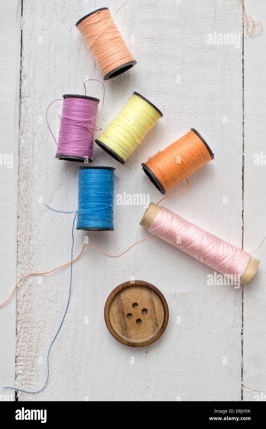 bobbins with thread on the table, from above Stock Photo - Alamy