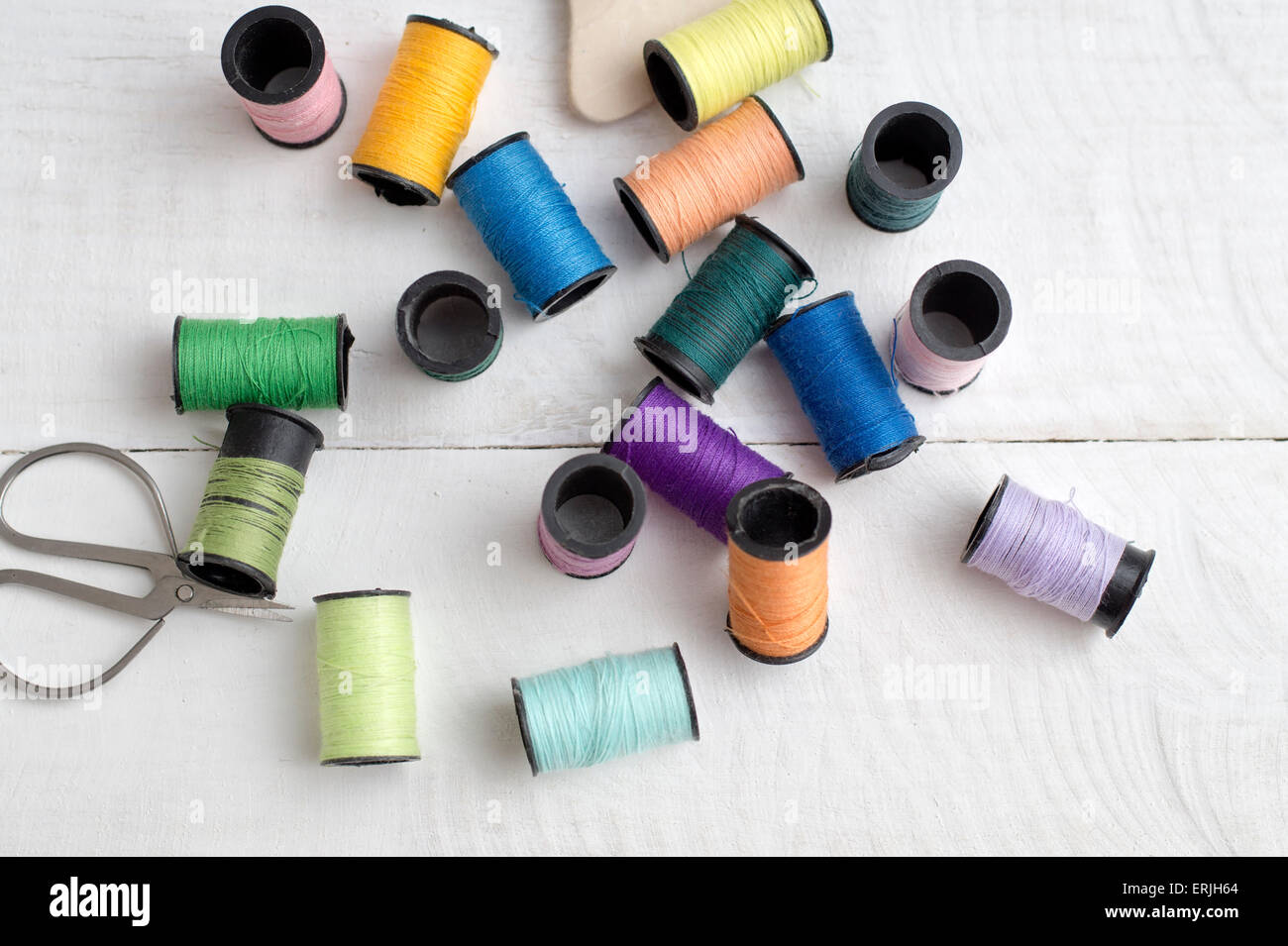 bobbins with thread on the table, from above Stock Photo - Alamy