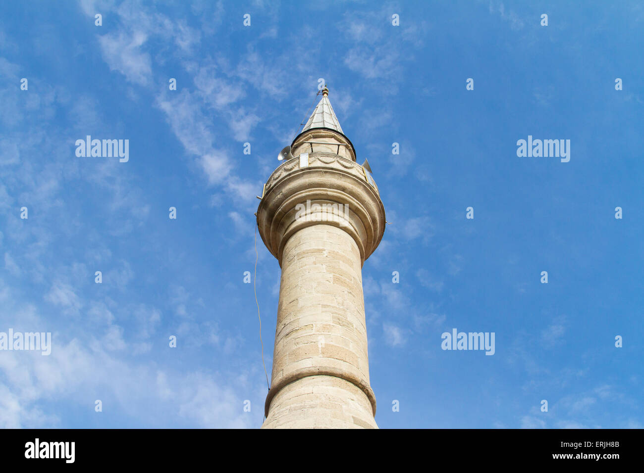 Single Islamic minaret of mosque on cloudy blue sky Stock Photo - Alamy