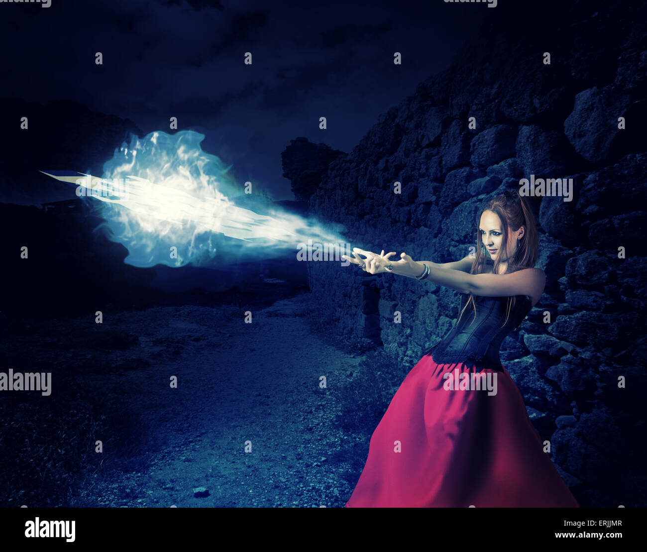 beautiful woman witch trains in medieval castle cast magic - blue cold ...