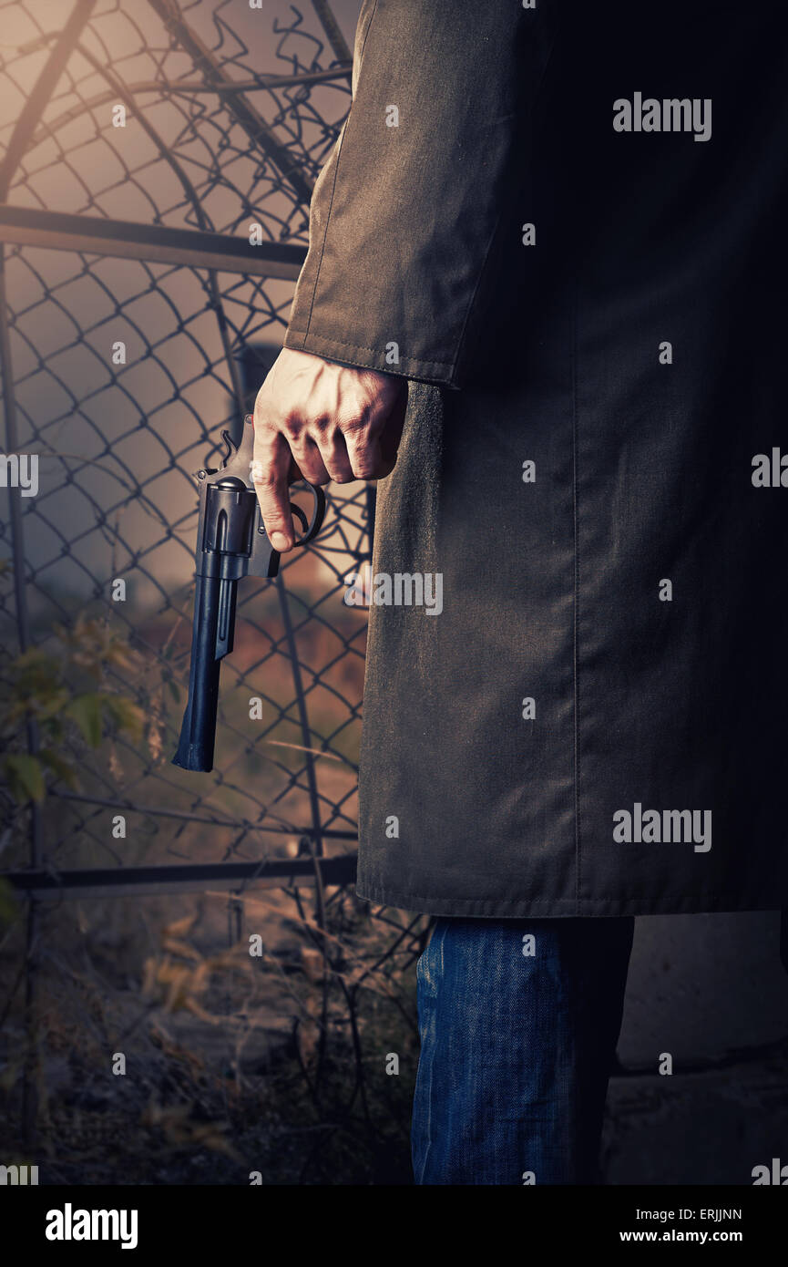 Male Hand with gun (revolver) outdoor Stock Photo - Alamy