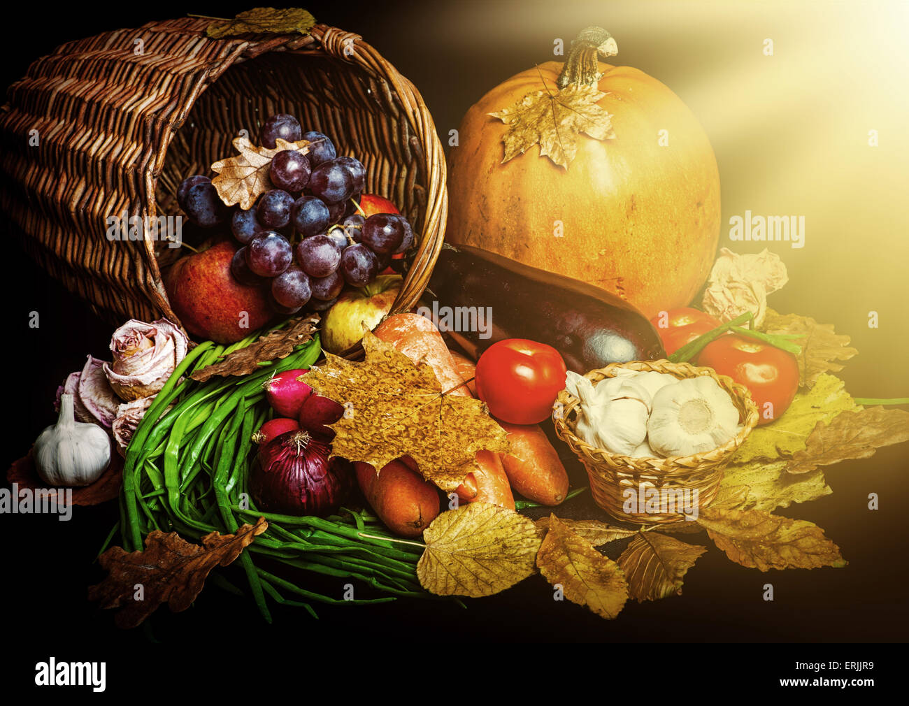 Beautiful autumn harvest of vegetables and leaves on black background ...