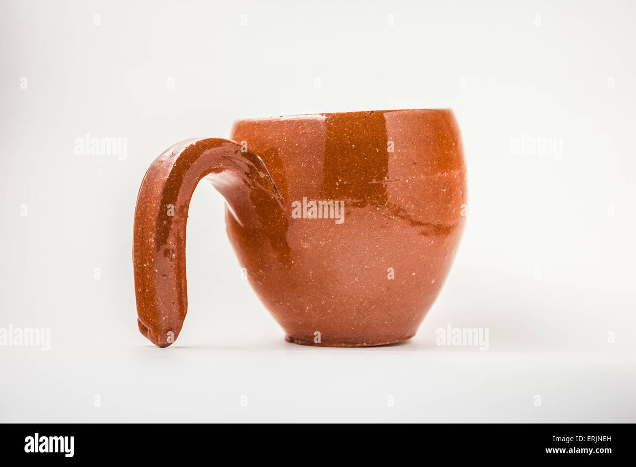 Old clay cup isolated on white background Stock Photo - Alamy