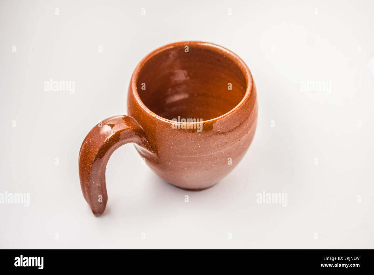 Old clay cup isolated on white background Stock Photo - Alamy