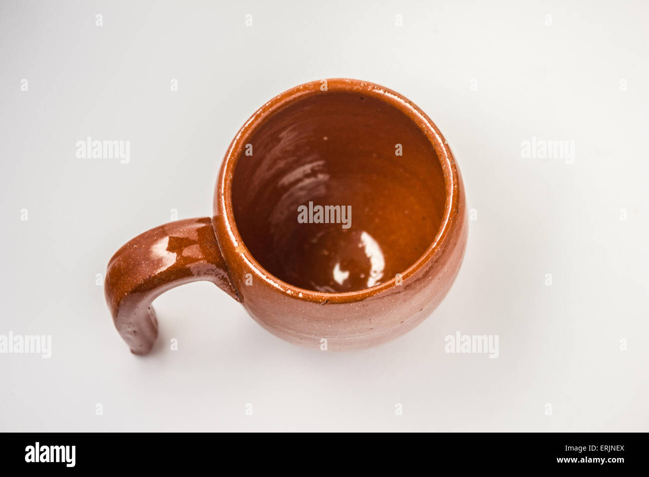 Old clay cup isolated on white background Stock Photo - Alamy