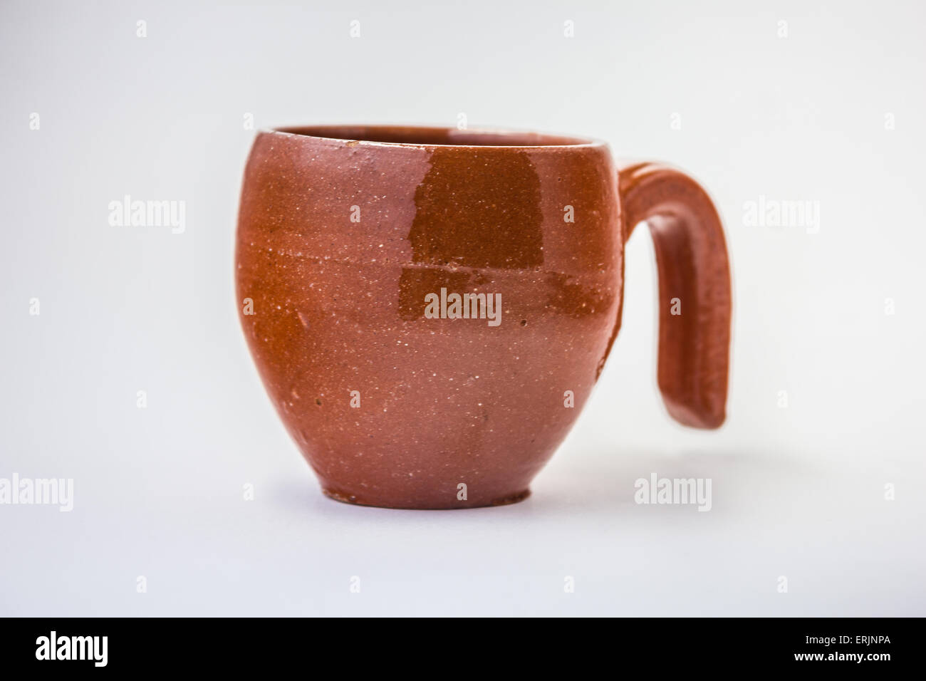 Old clay cup isolated on white background Stock Photo - Alamy