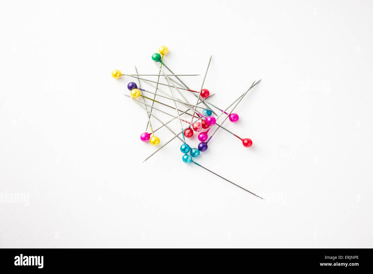Colorful stack of sewing needles in white background Stock Photo - Alamy