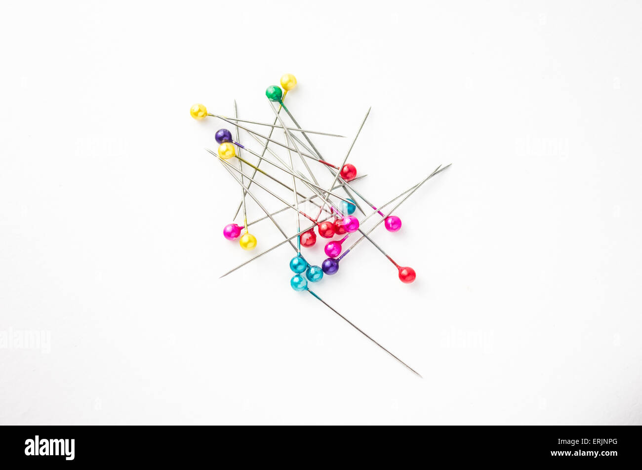 Colorful stack of sewing needles in white background Stock Photo - Alamy