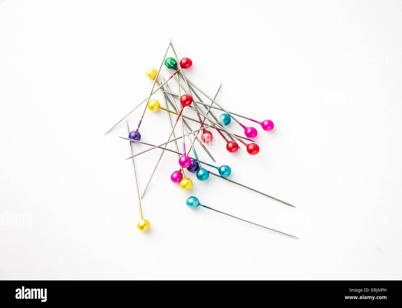 Colorful stack of sewing needles in white background Stock Photo - Alamy
