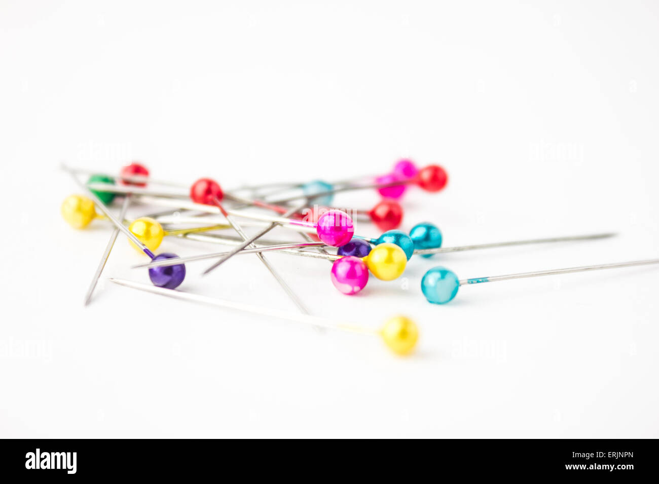 Colorful stack of sewing needles in white background Stock Photo - Alamy