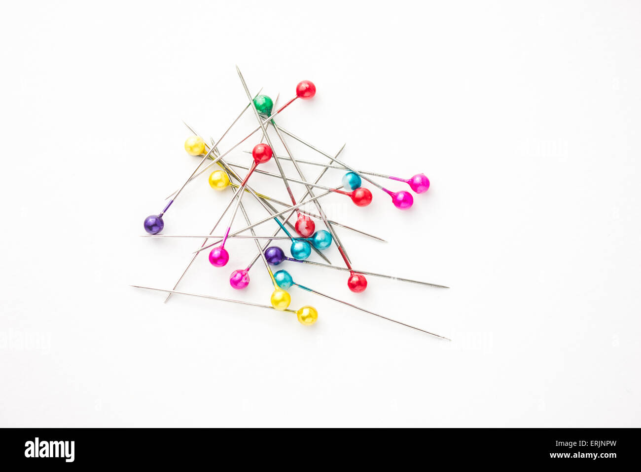 Colorful stack of sewing needles in white background Stock Photo - Alamy