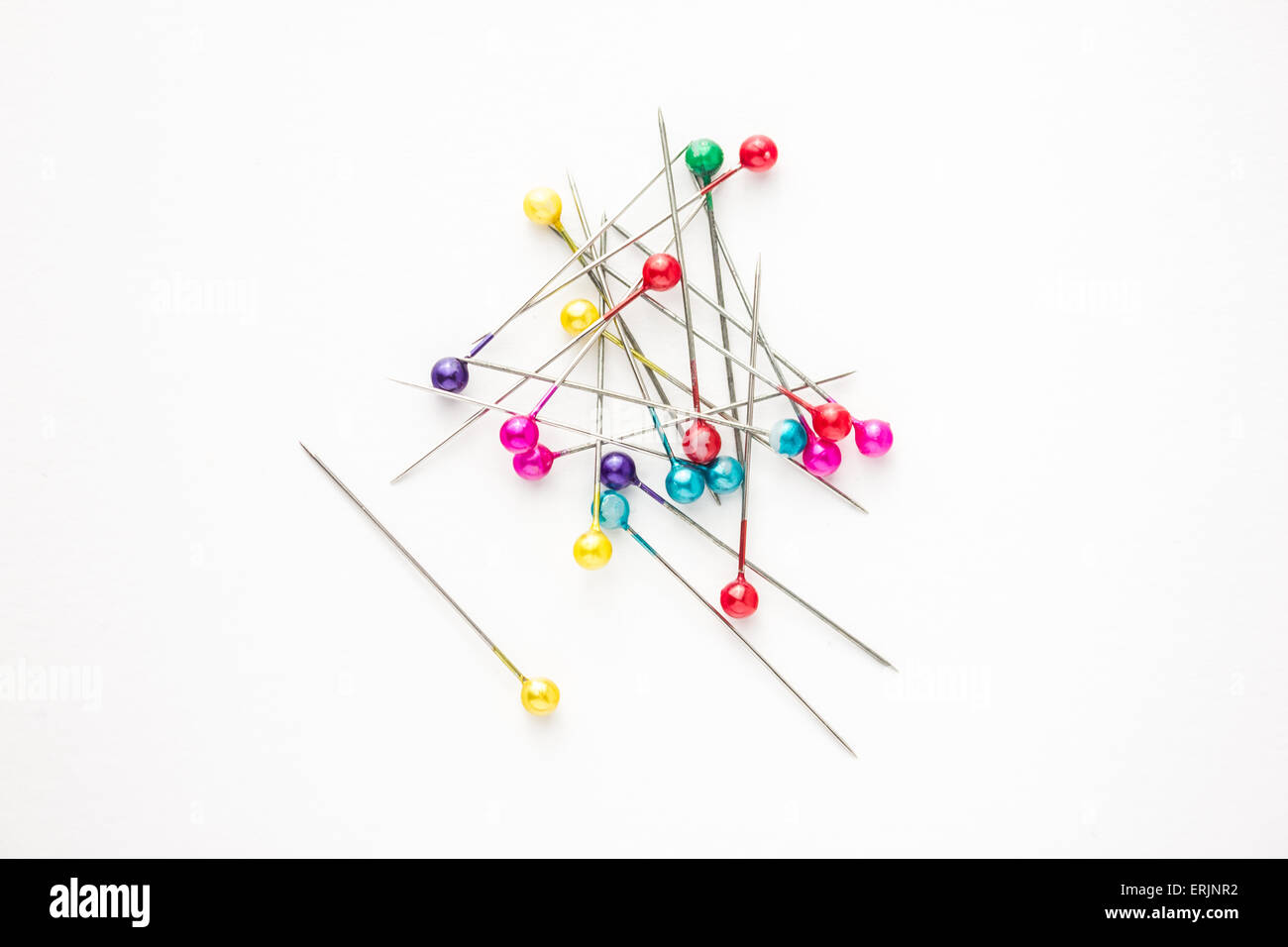 Colorful stack of sewing needles in white background Stock Photo - Alamy