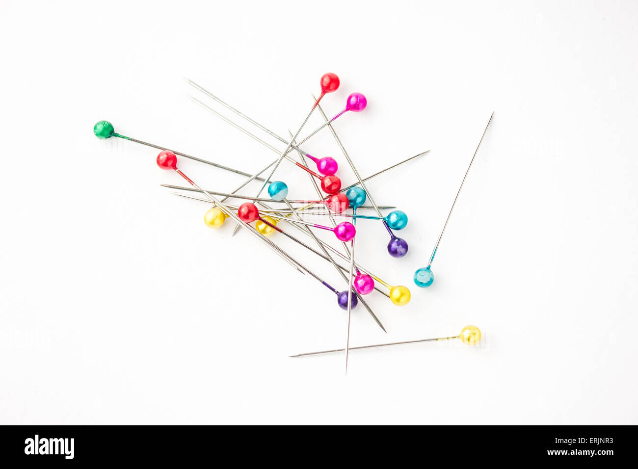 Colorful stack of sewing needles in white background Stock Photo - Alamy