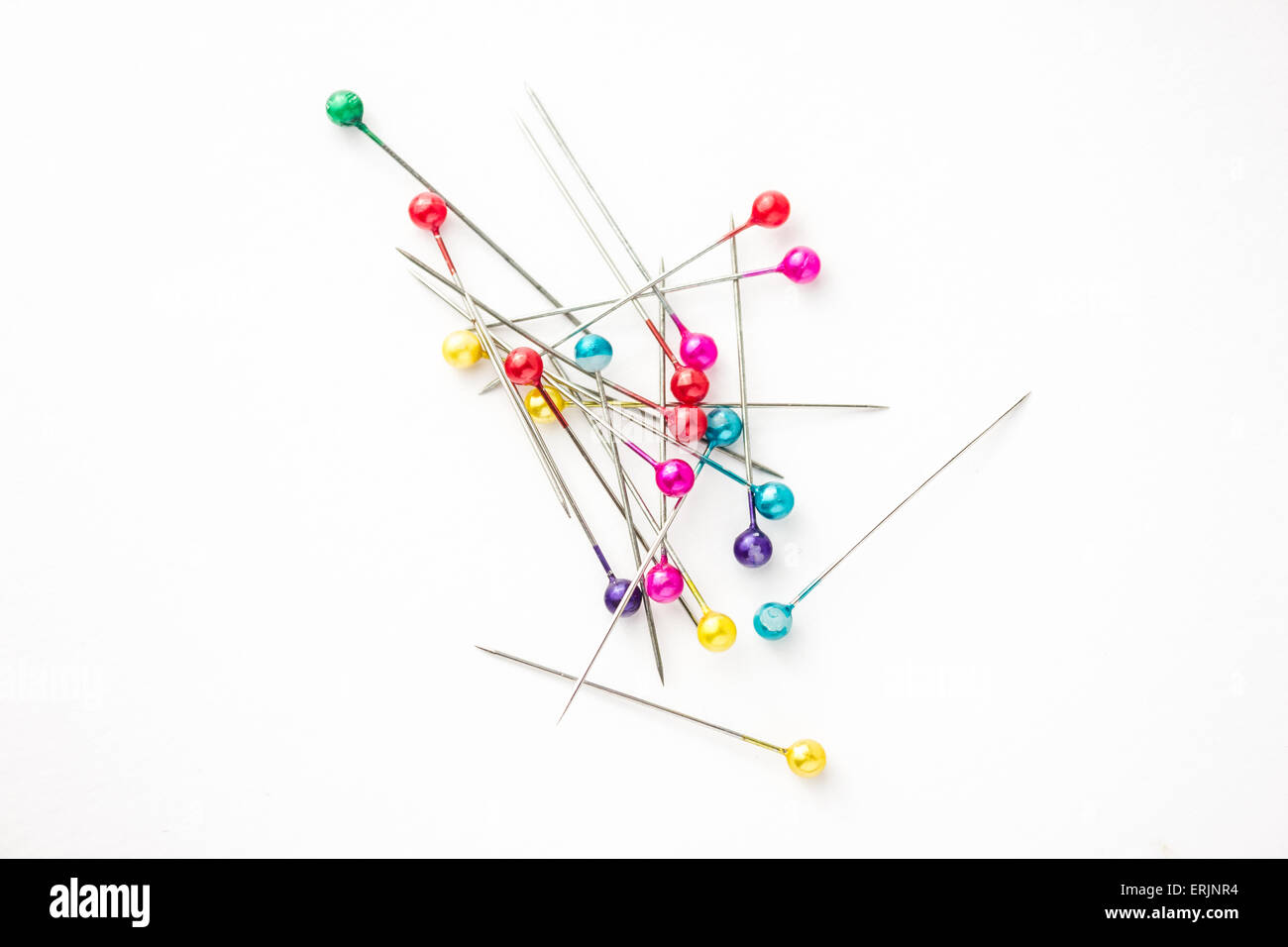 Colorful stack of sewing needles in white background Stock Photo - Alamy