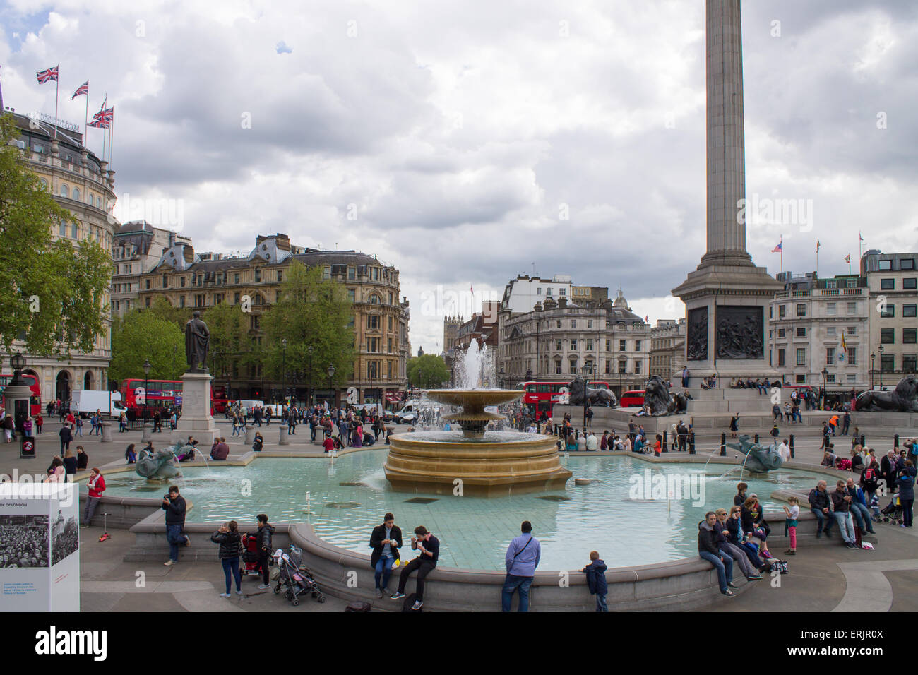 Tourists in the Trafalgar Square. Nelson's Column on the background ...