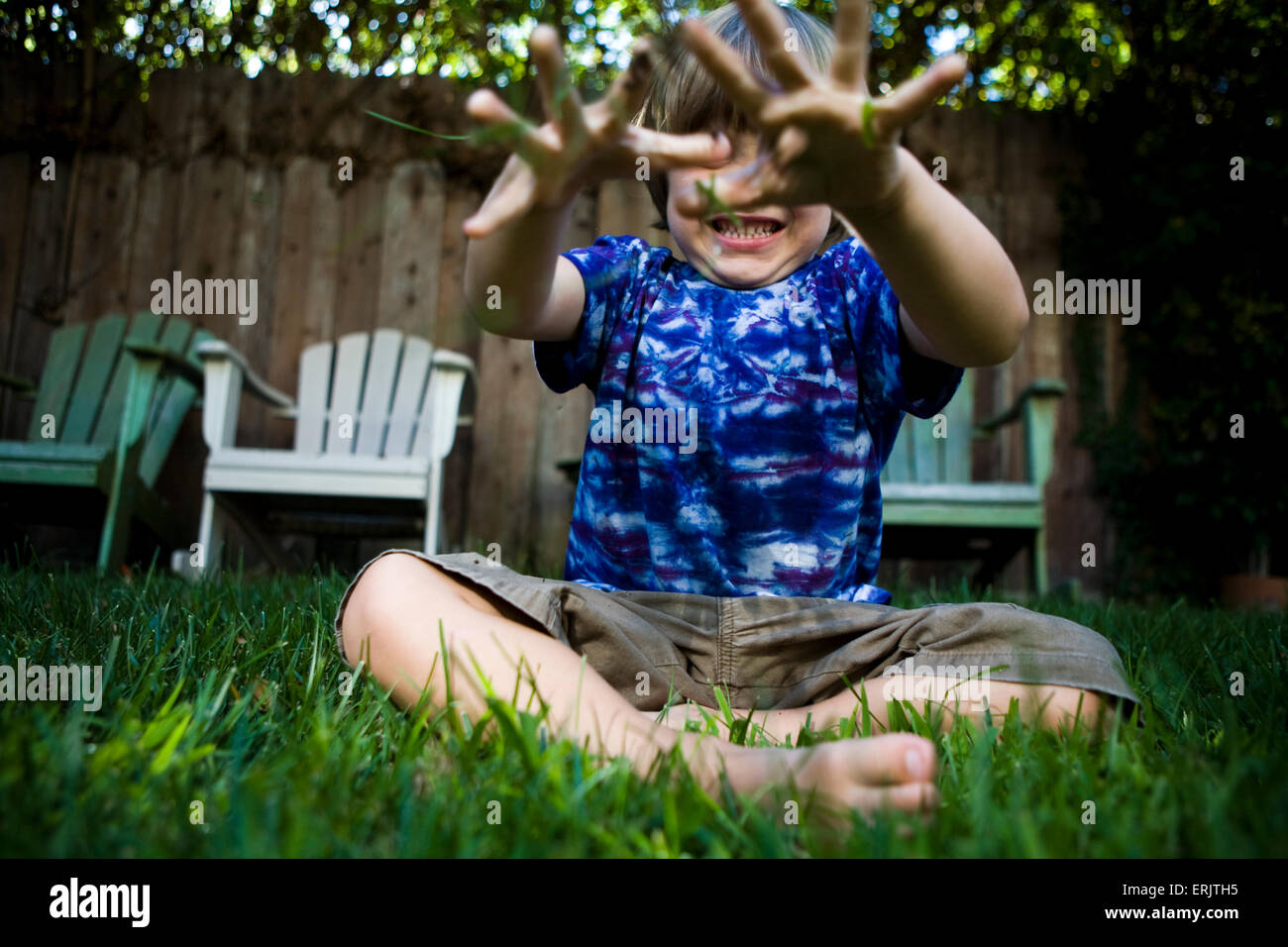 young cute boy playing in backyard Stock Photo - Alamy