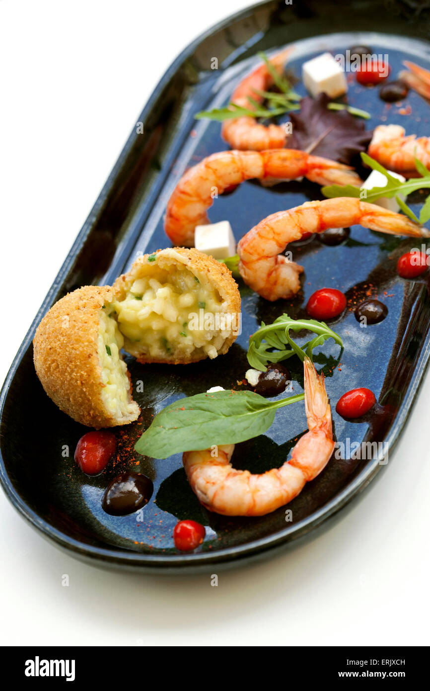Risotto fritters, prawns, tomato sauce and olives, coconut cubes Stock ...