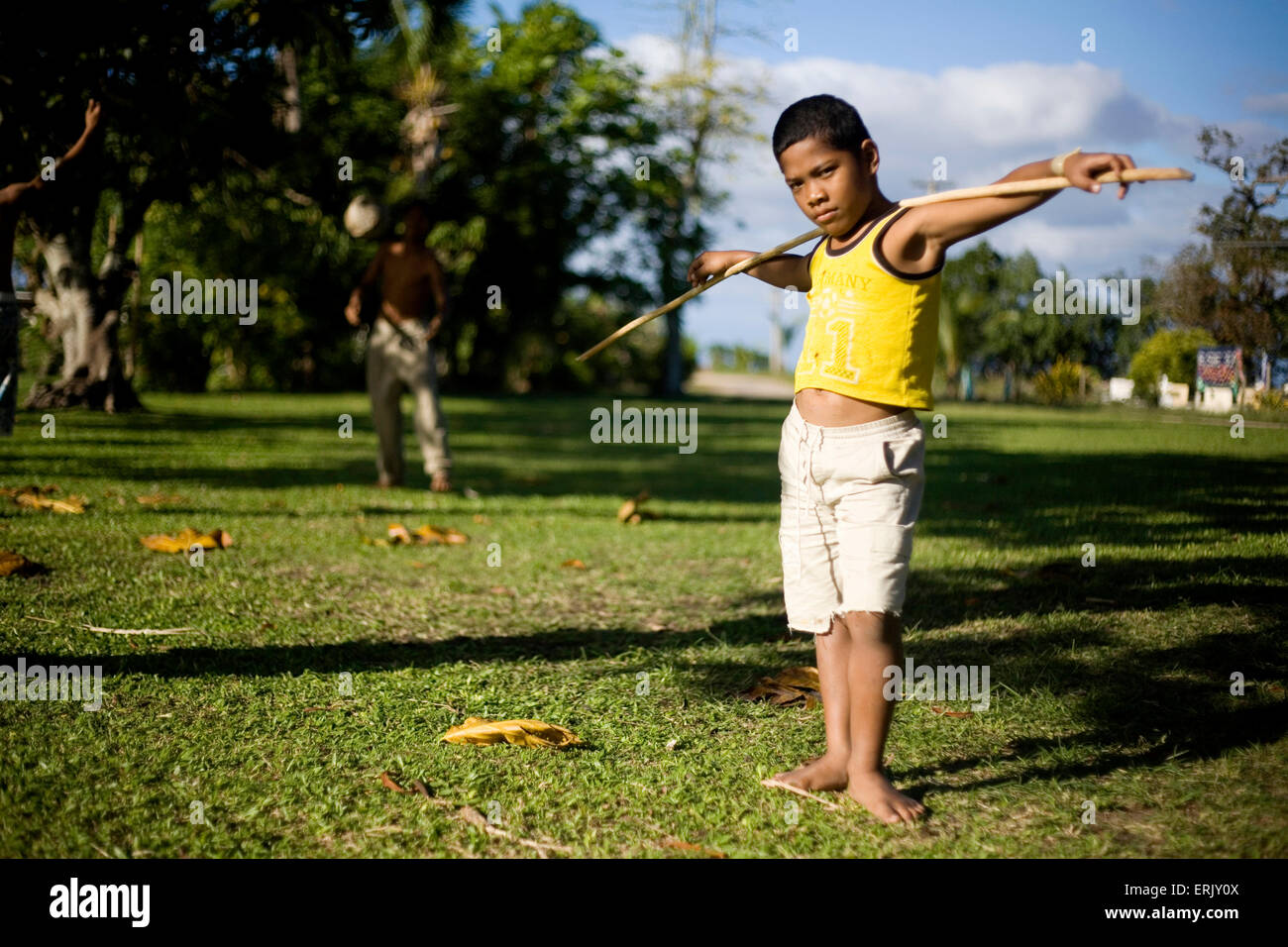 A portrait of a young boy holding a pole around his shoulders Stock ...