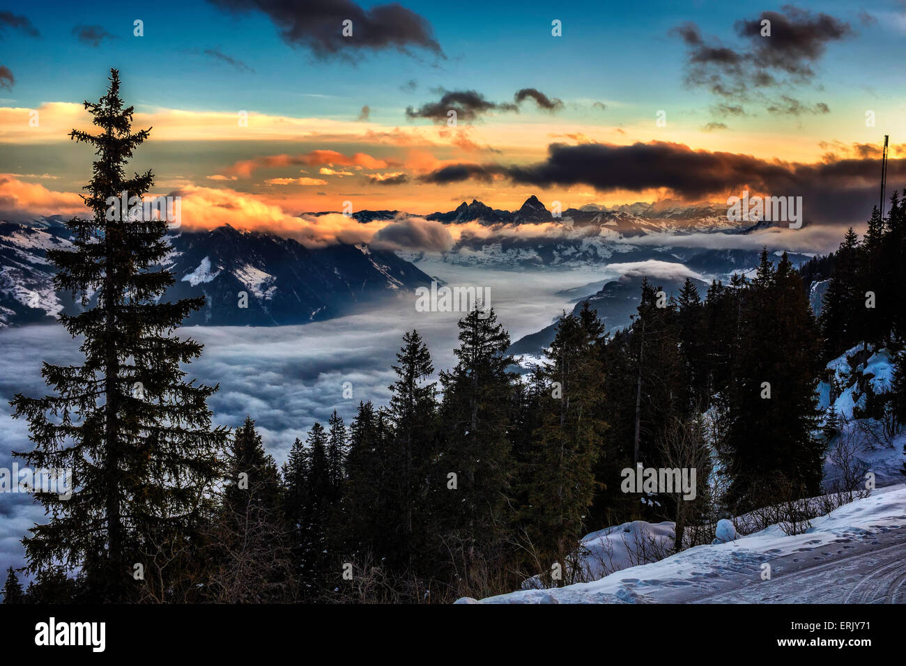 Beautiful sunrise above clouds in Swiss Alps Stock Photo - Alamy