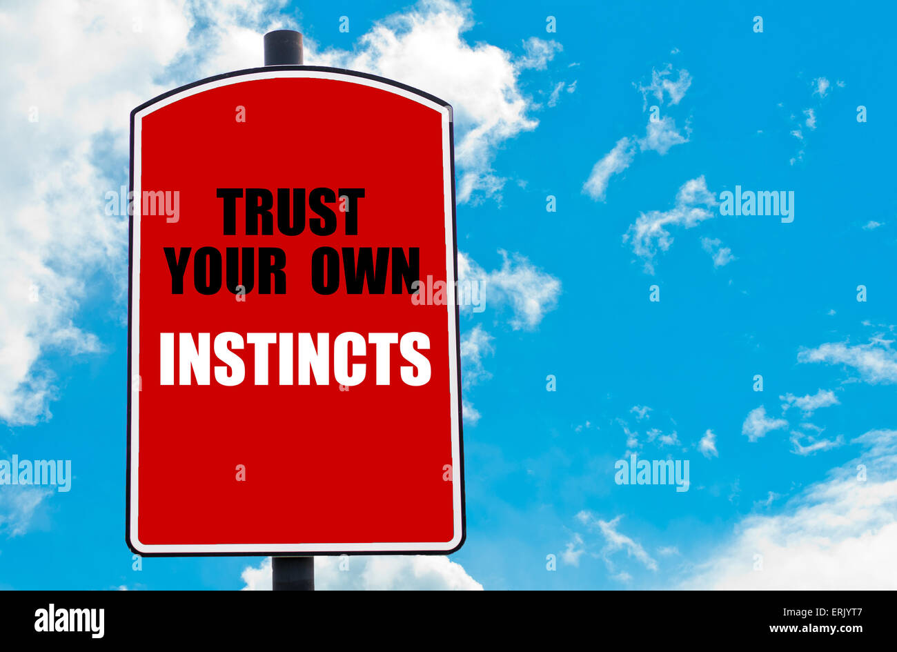 Trust Your Own Instincts motivational quote written on red road sign isolated over clear blue ...