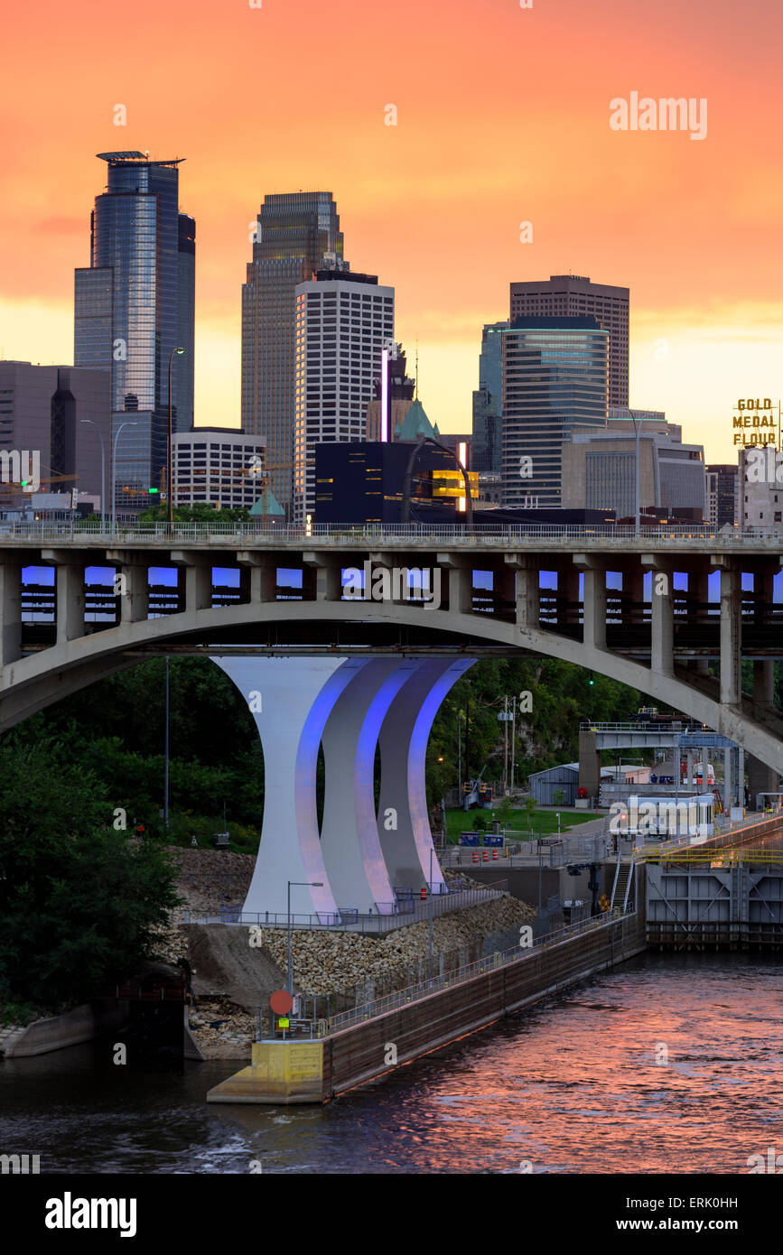 Minneapolis skyline and Tenth Avenue bridge with orange storm light ...