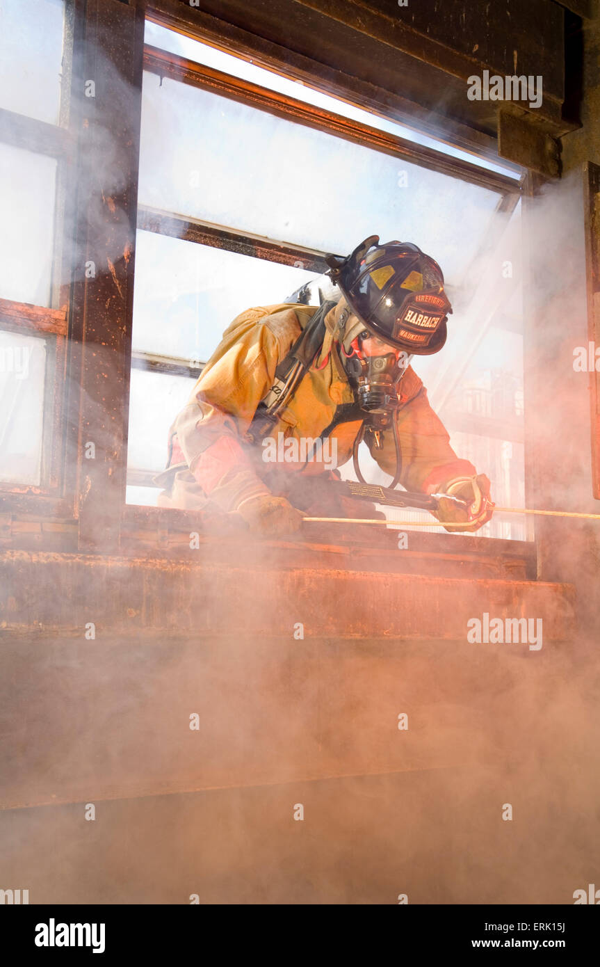 A firefighter practices fast escape drills while surrounded by ...