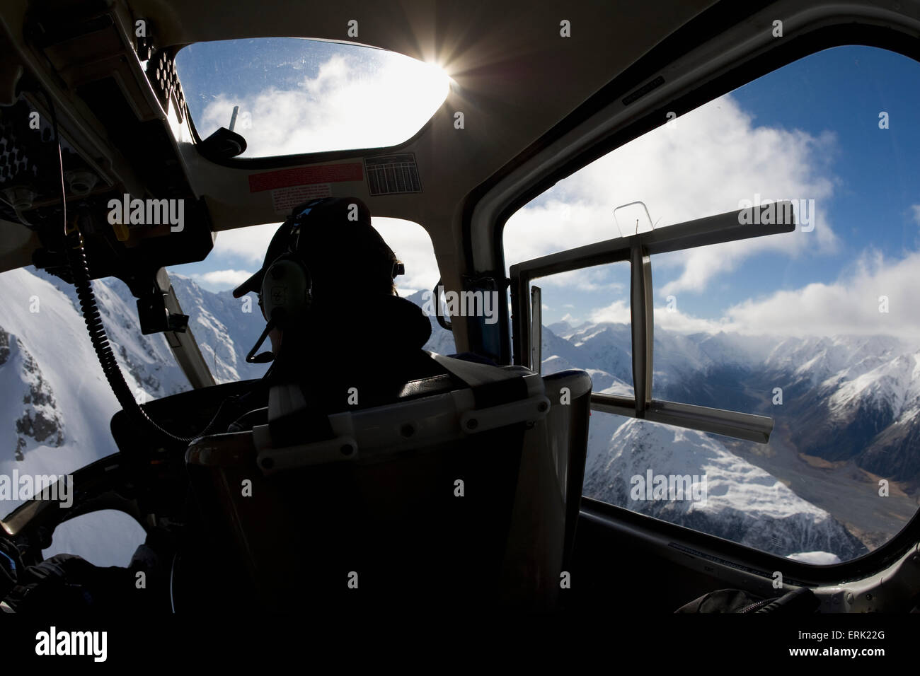 View of helicopter pilot in a cockpit looking out over the snowy ...