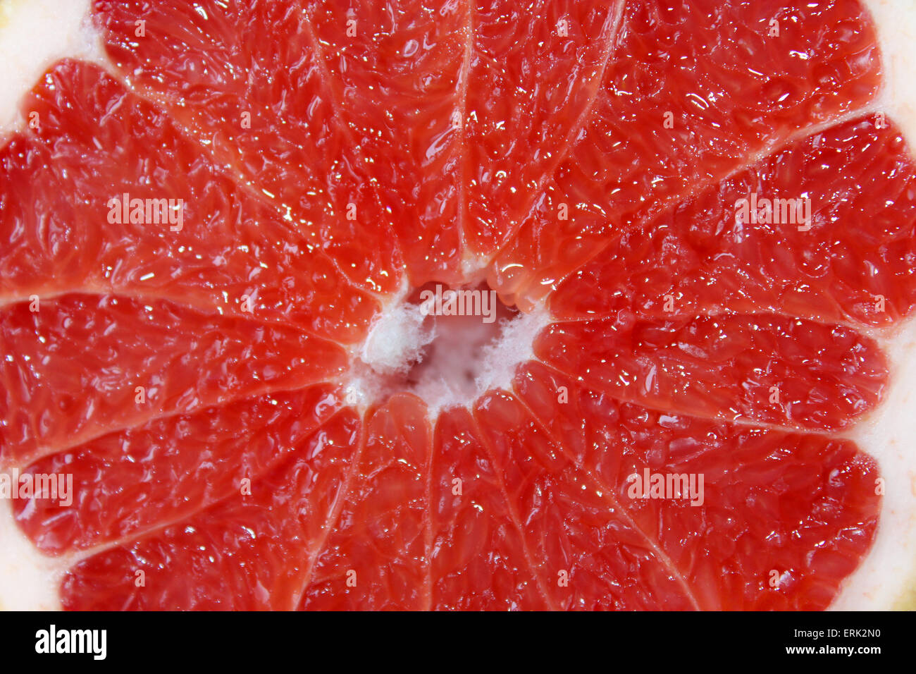 cut fruit of red grapefruit on the board Stock Photo - Alamy