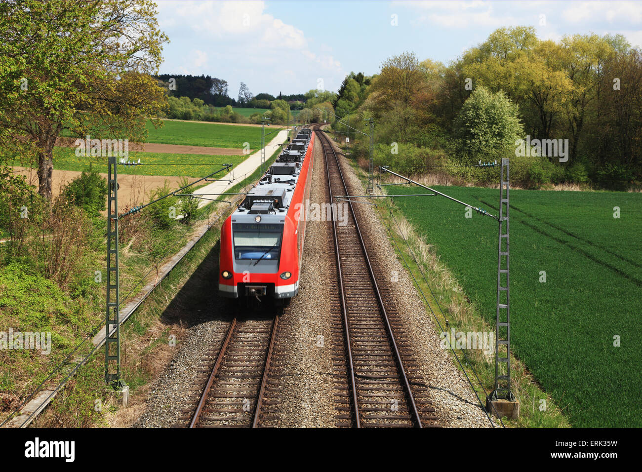 A train on the tracks in the countryside; Gilching, Bayern, Germany ...