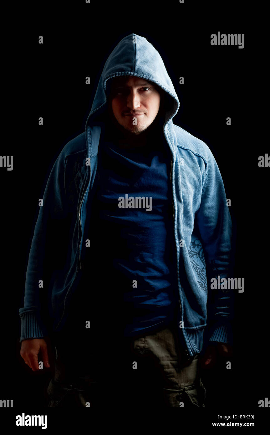 Young man standing on dark background Stock Photo - Alamy