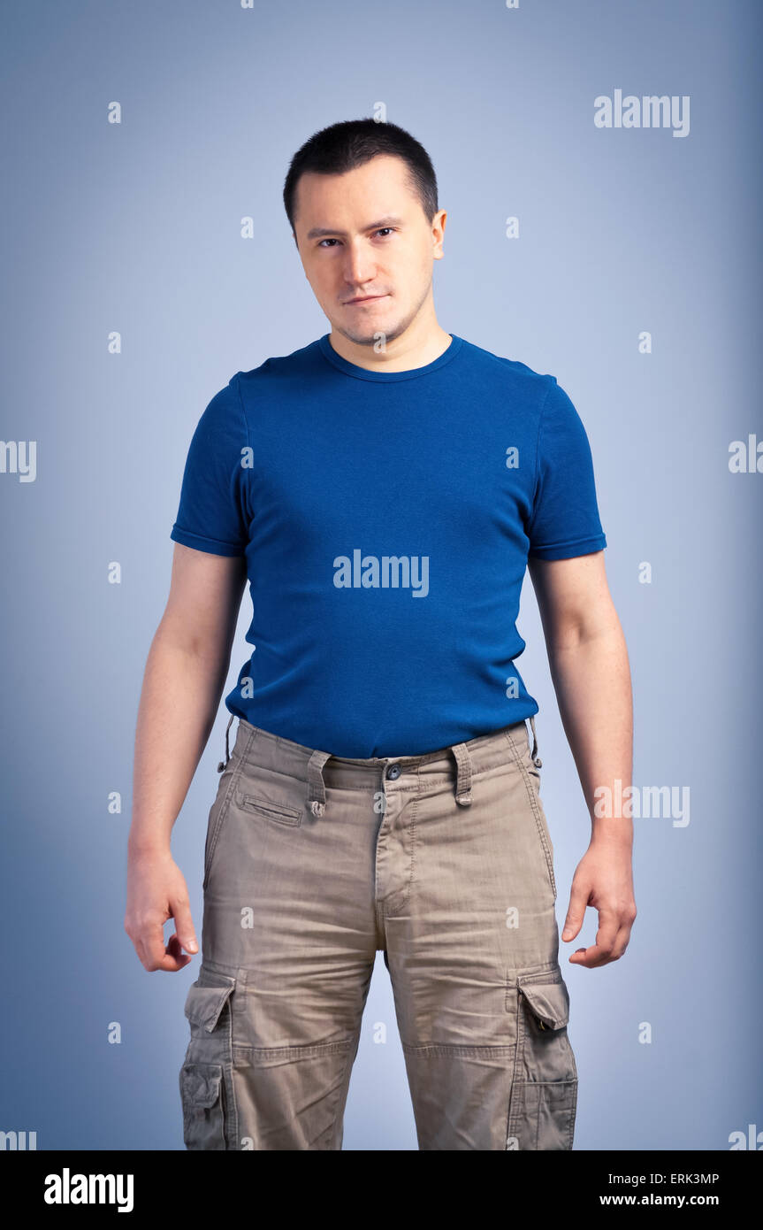 Portrait of an adult man standing with a smirk face Stock Photo - Alamy