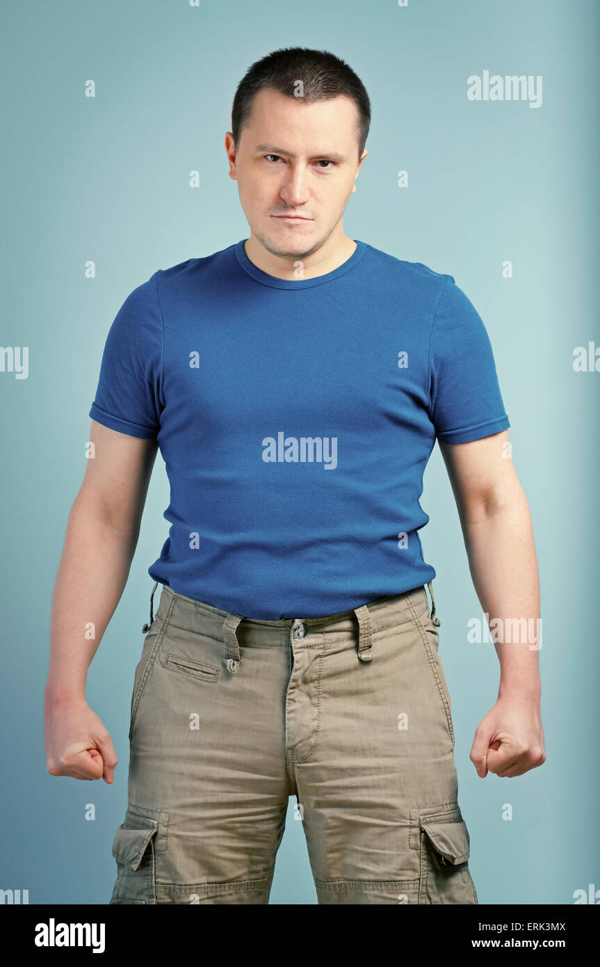 Portrait of an adult man standing with a aggressive face Stock Photo ...