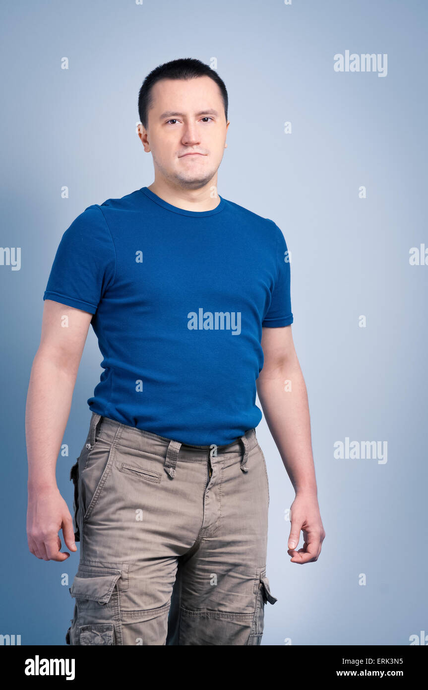 Portrait of an adult man standing with a smirk face Stock Photo - Alamy