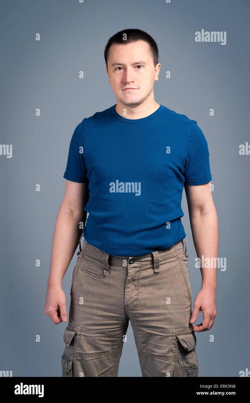Portrait of an adult man standing with a smirk face Stock Photo - Alamy