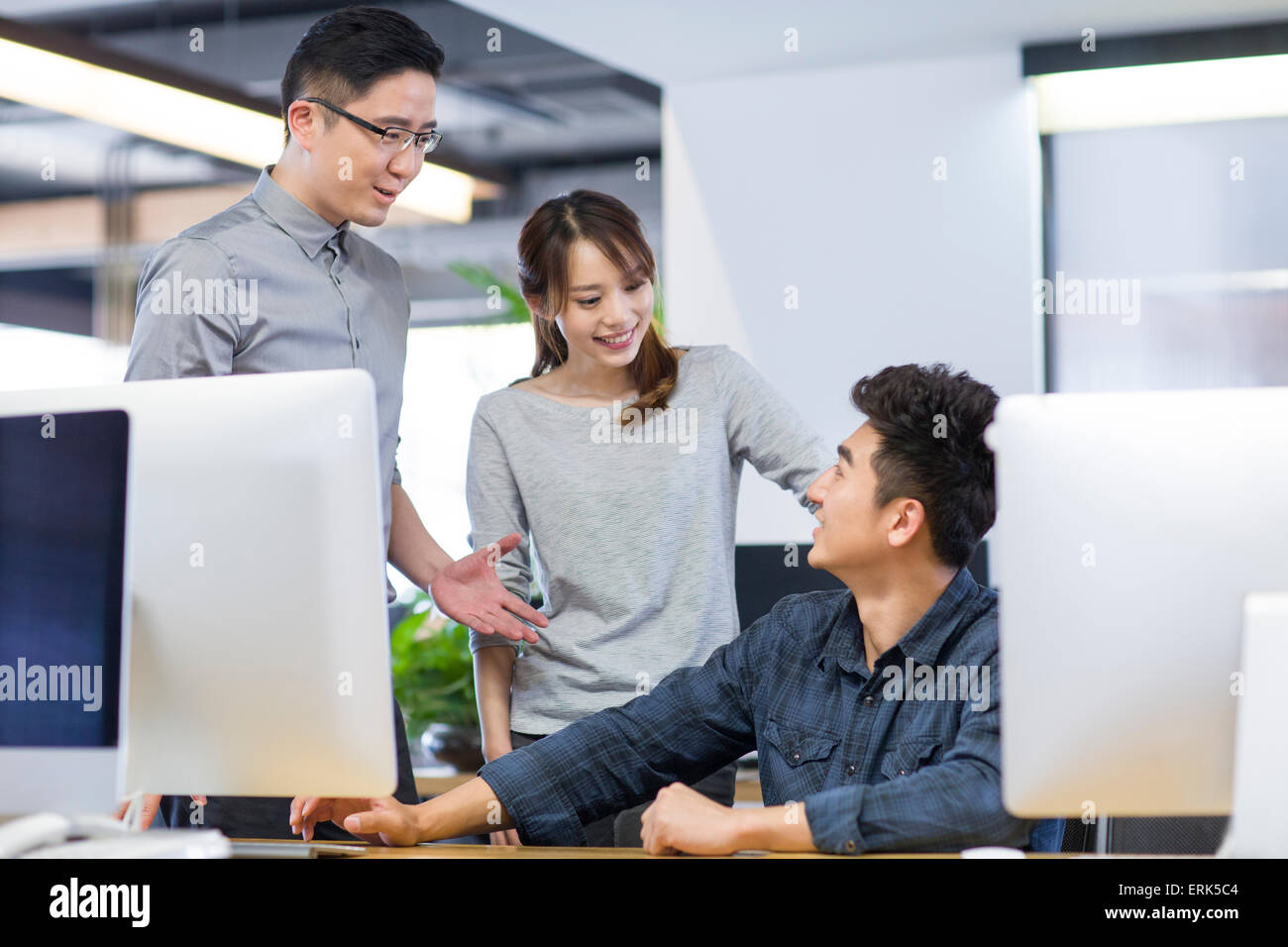 IT workers talking in office Stock Photo - Alamy
