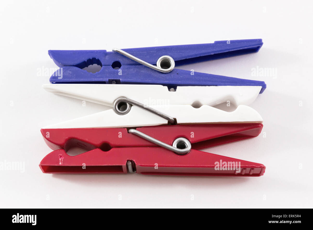 Red white and blue plastic pegs on a white background Stock Photo - Alamy