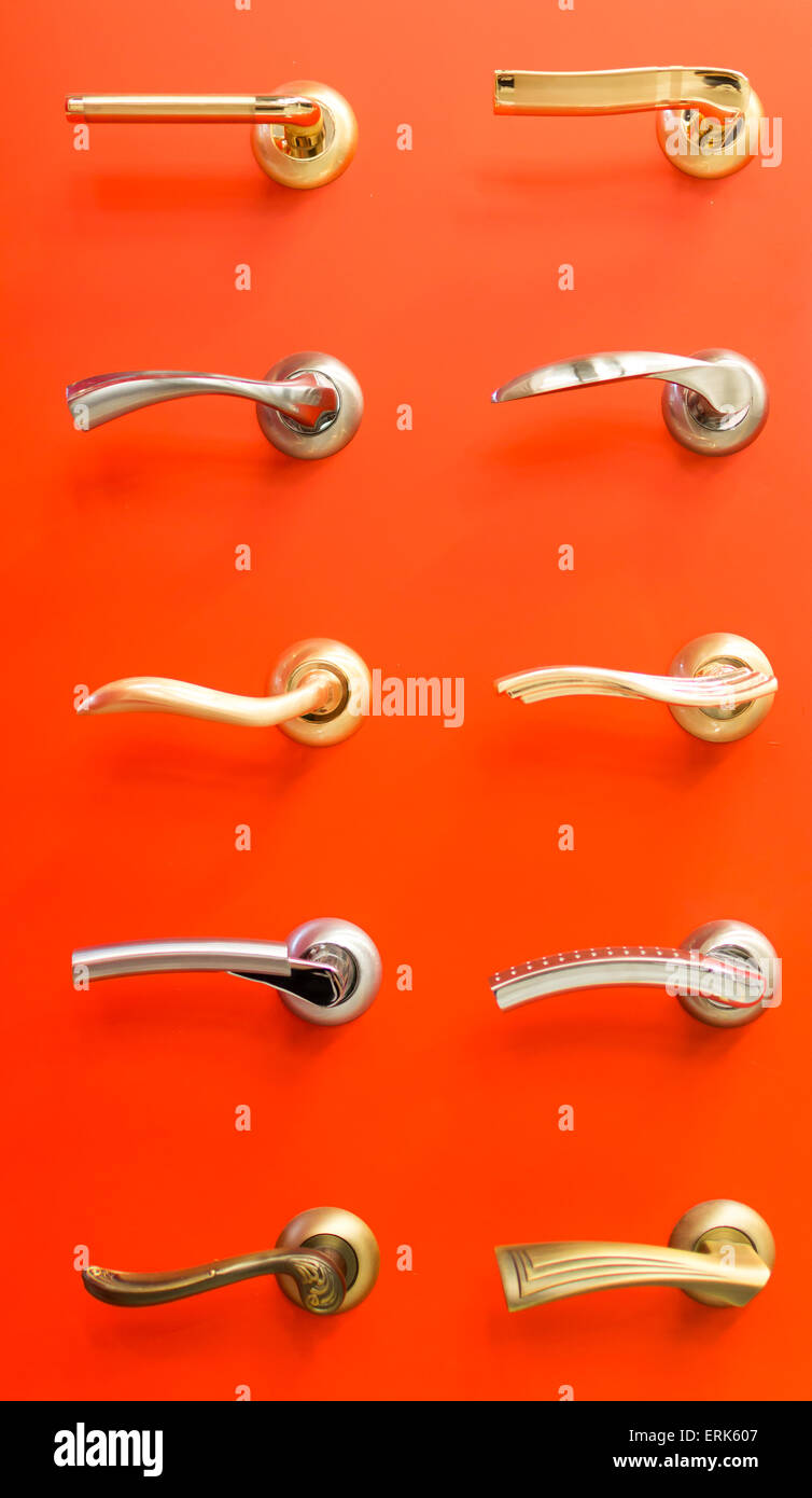 Arrangement of antique classic door handles on a red background Stock ...