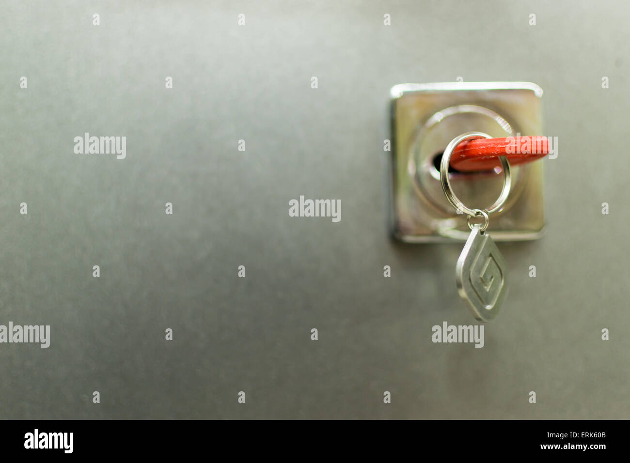 Single locked chrome door lock and key with tag Stock Photo - Alamy