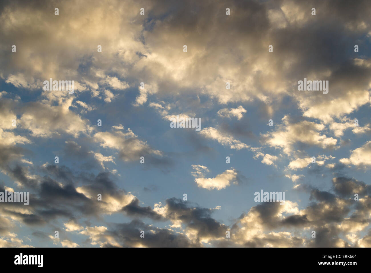 Sunset light illuminates a cloudy evening sky Stock Photo - Alamy